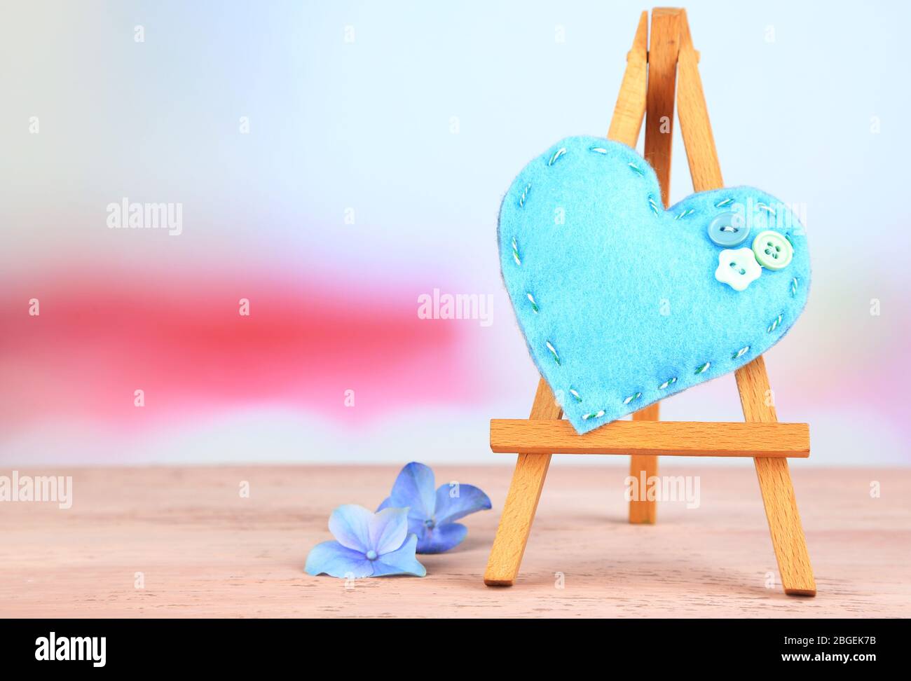 Beautiful heart small decorative easel on pink table Stock Photo - Alamy