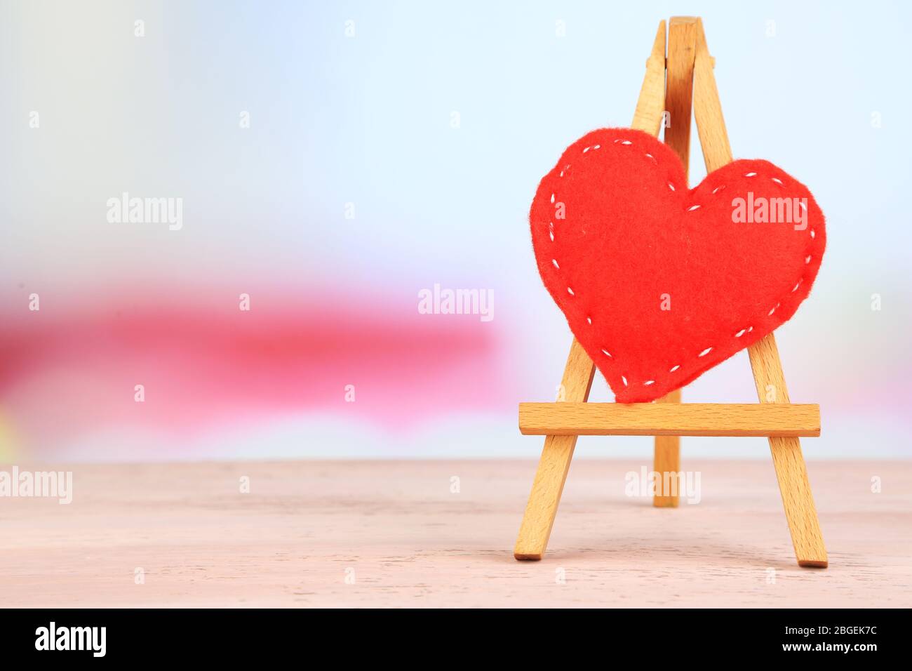 Beautiful heart small decorative easel on pink table Stock Photo - Alamy