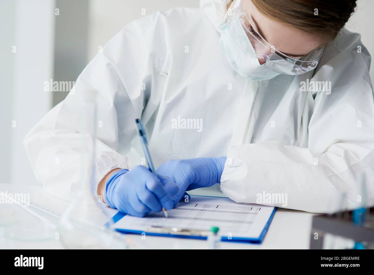 Female technician making notes after medical exam Stock Photo - Alamy