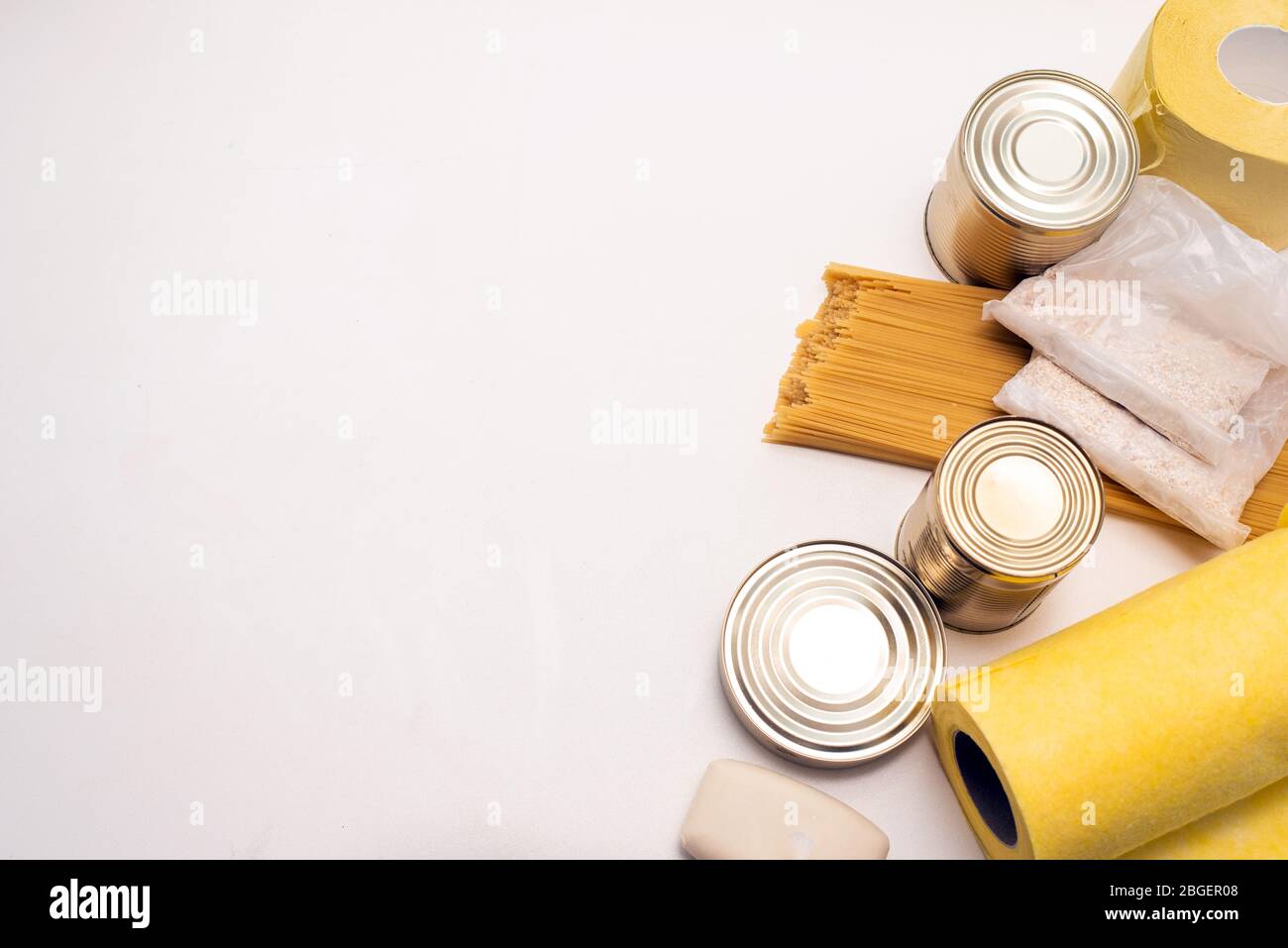 Various canned food, pasta, toilet paper and cereals on blue background ...