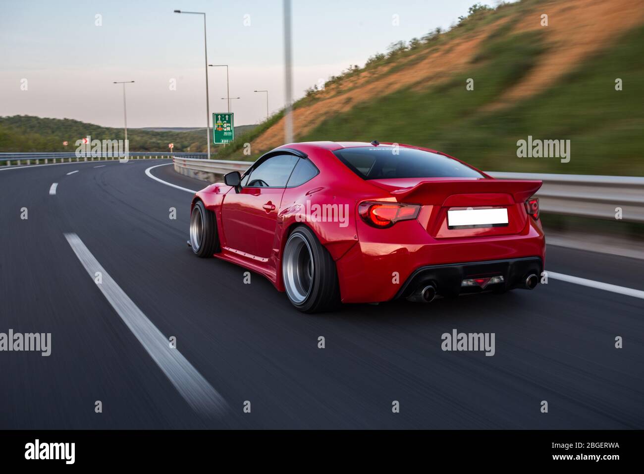 Red elegant sport car landscape drive Stock Photo - Alamy