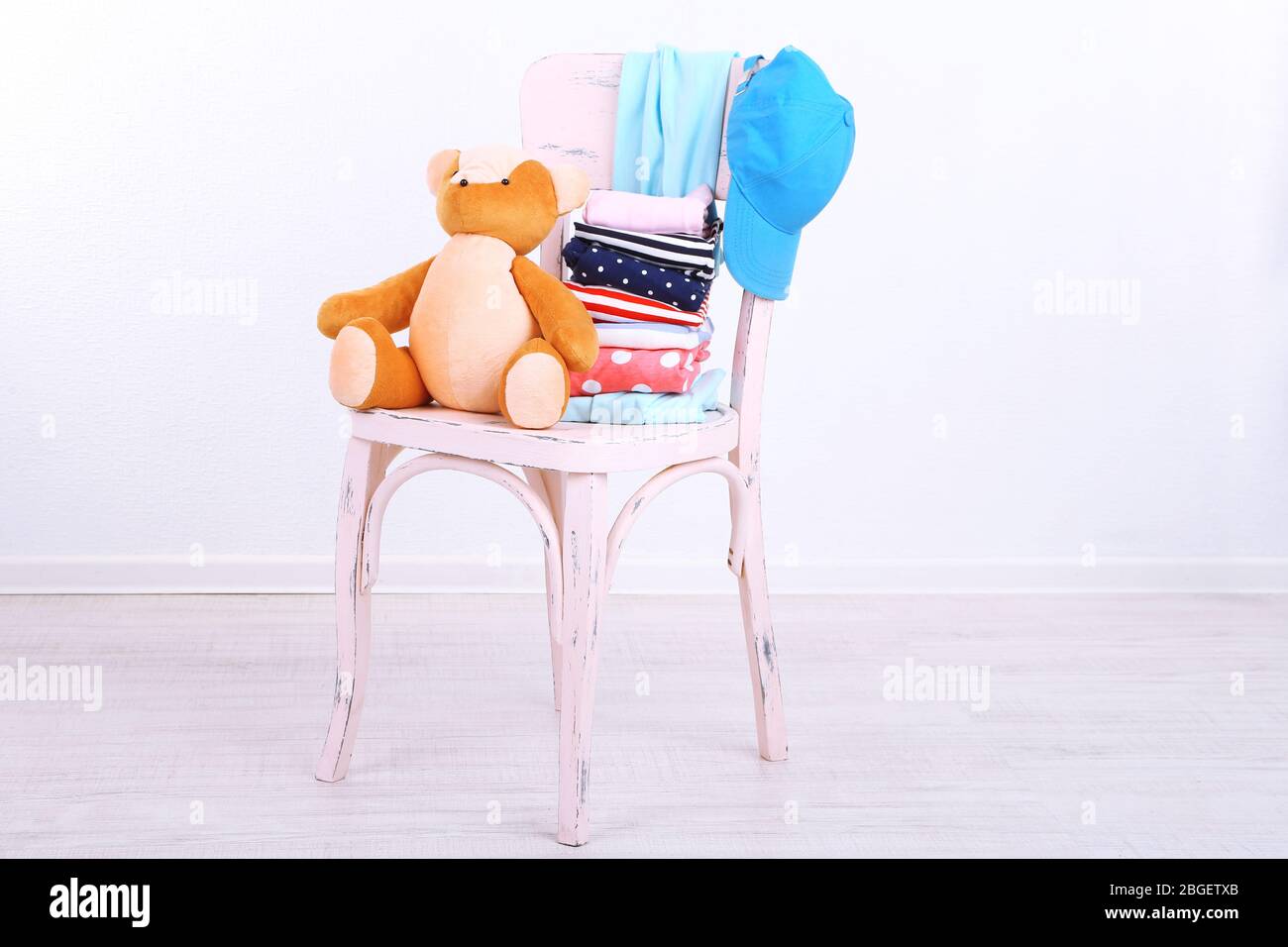 Clothes on chair on gray wall background Stock Photo - Alamy