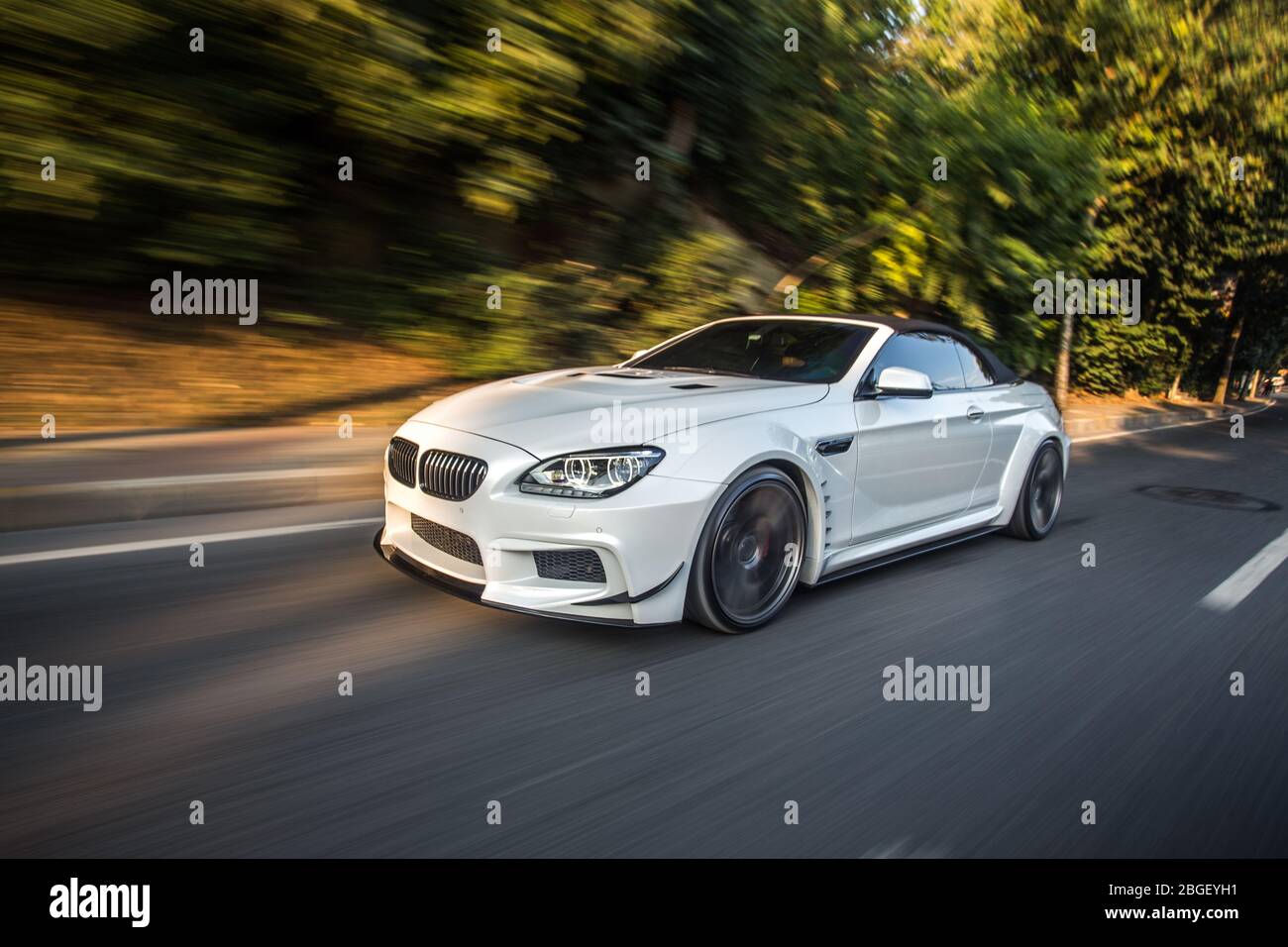 White classic car on the road in the rain forest Stock Photo - Alamy