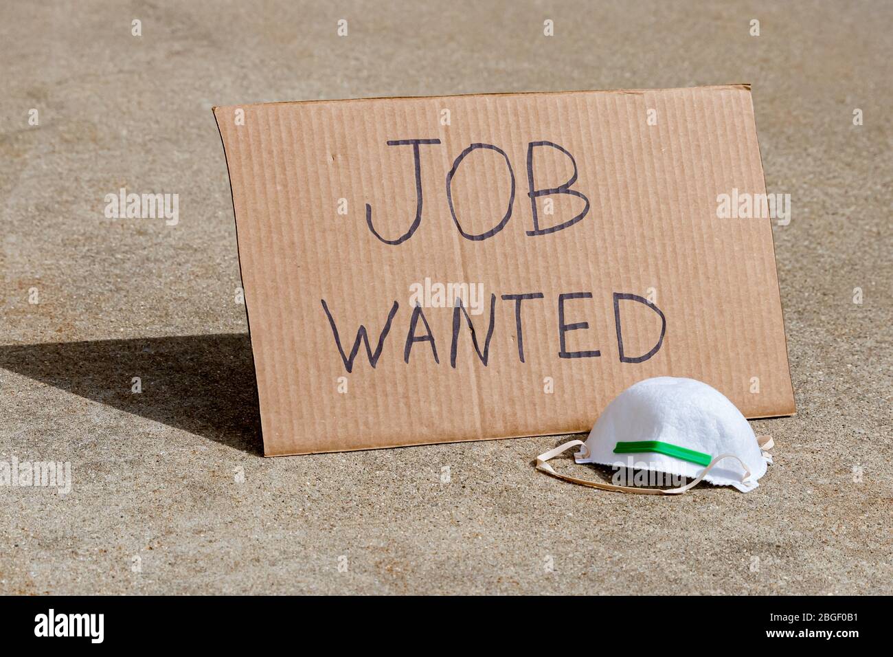 Job wanted cardboard sign and N94 respirator mask. Concept of recession ...