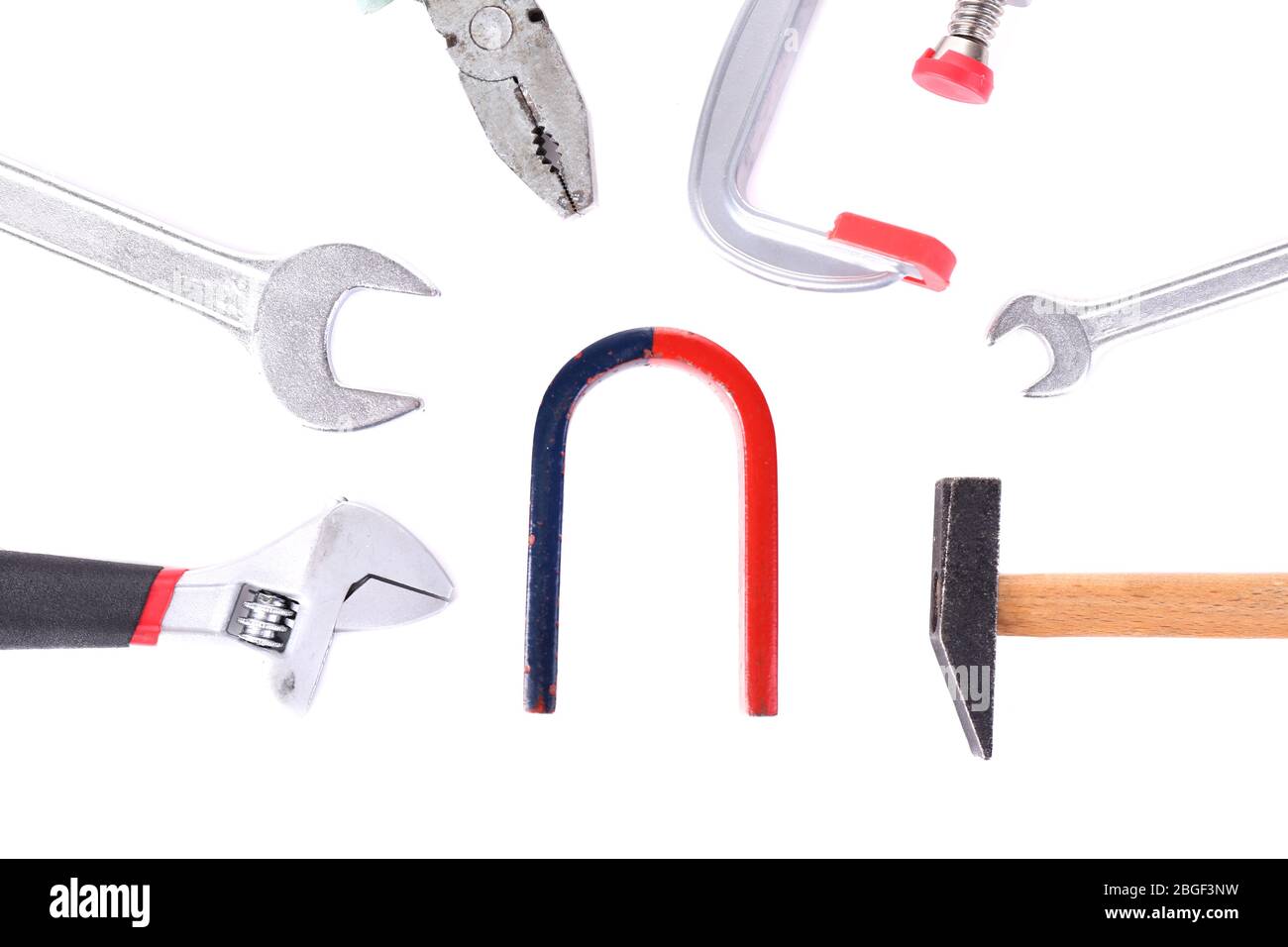 Composition of magnet and tools isolated on white Stock Photo - Alamy