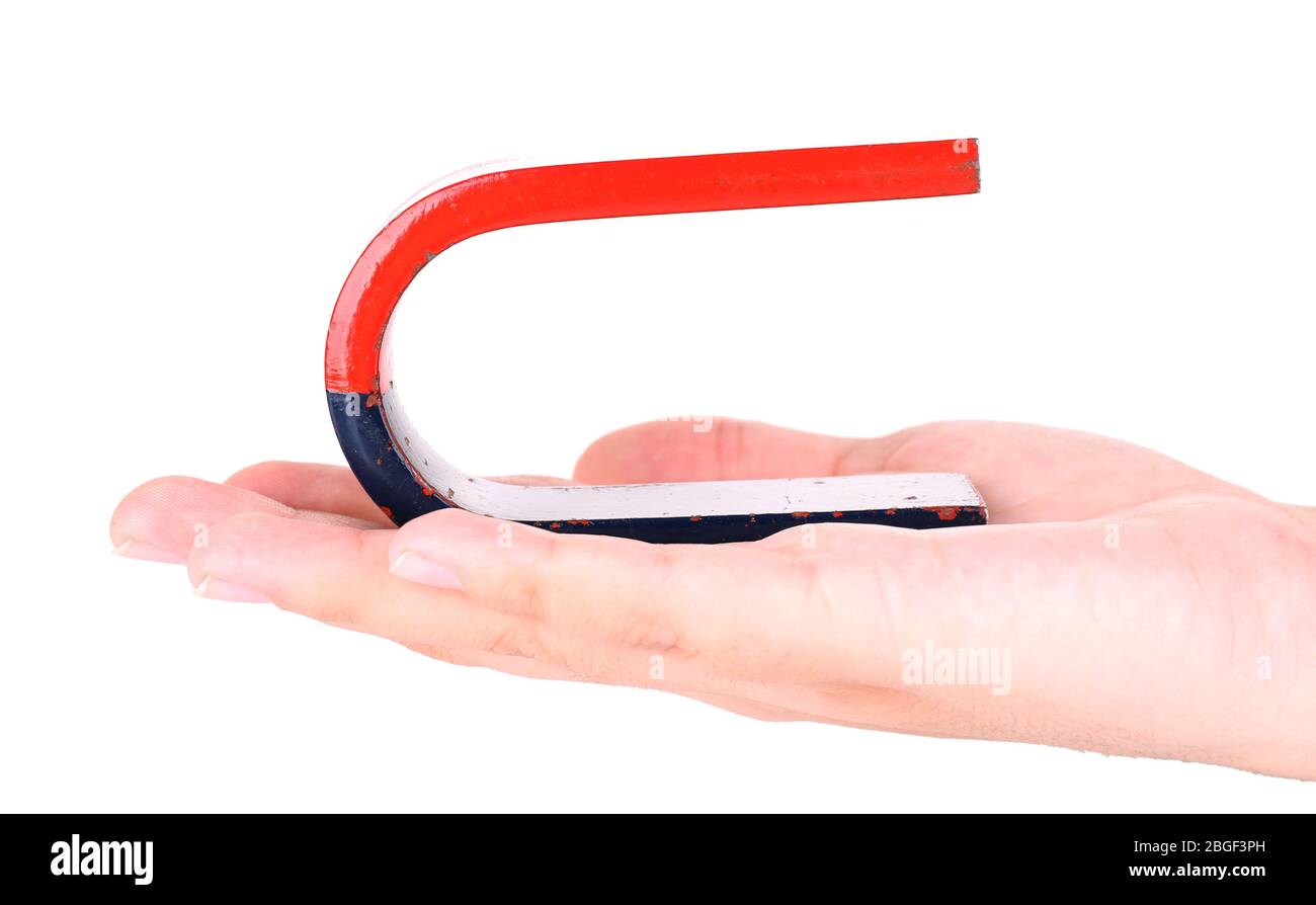 Hand holding horseshoe magnet Cut Out Stock Images & Pictures - Alamy