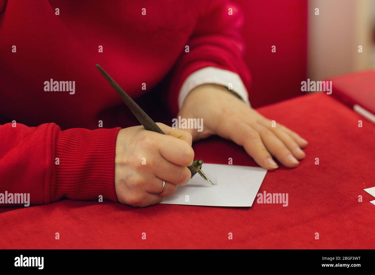 Female hands hold a pen for calligraphy Stock Photo - Alamy