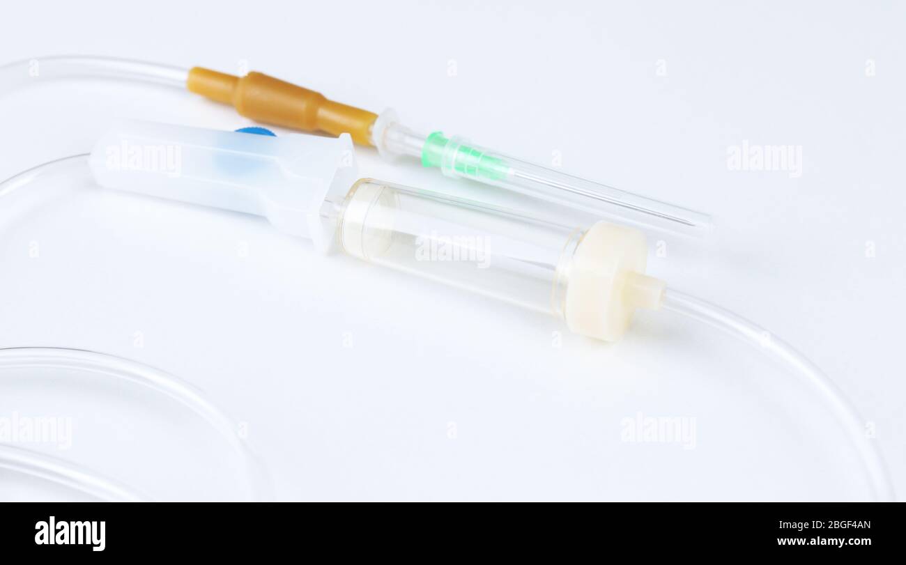 Disposable infusion set on grey background Stock Photo - Alamy