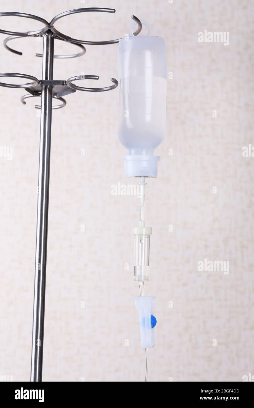 Disposable infusion set on wall background Stock Photo - Alamy