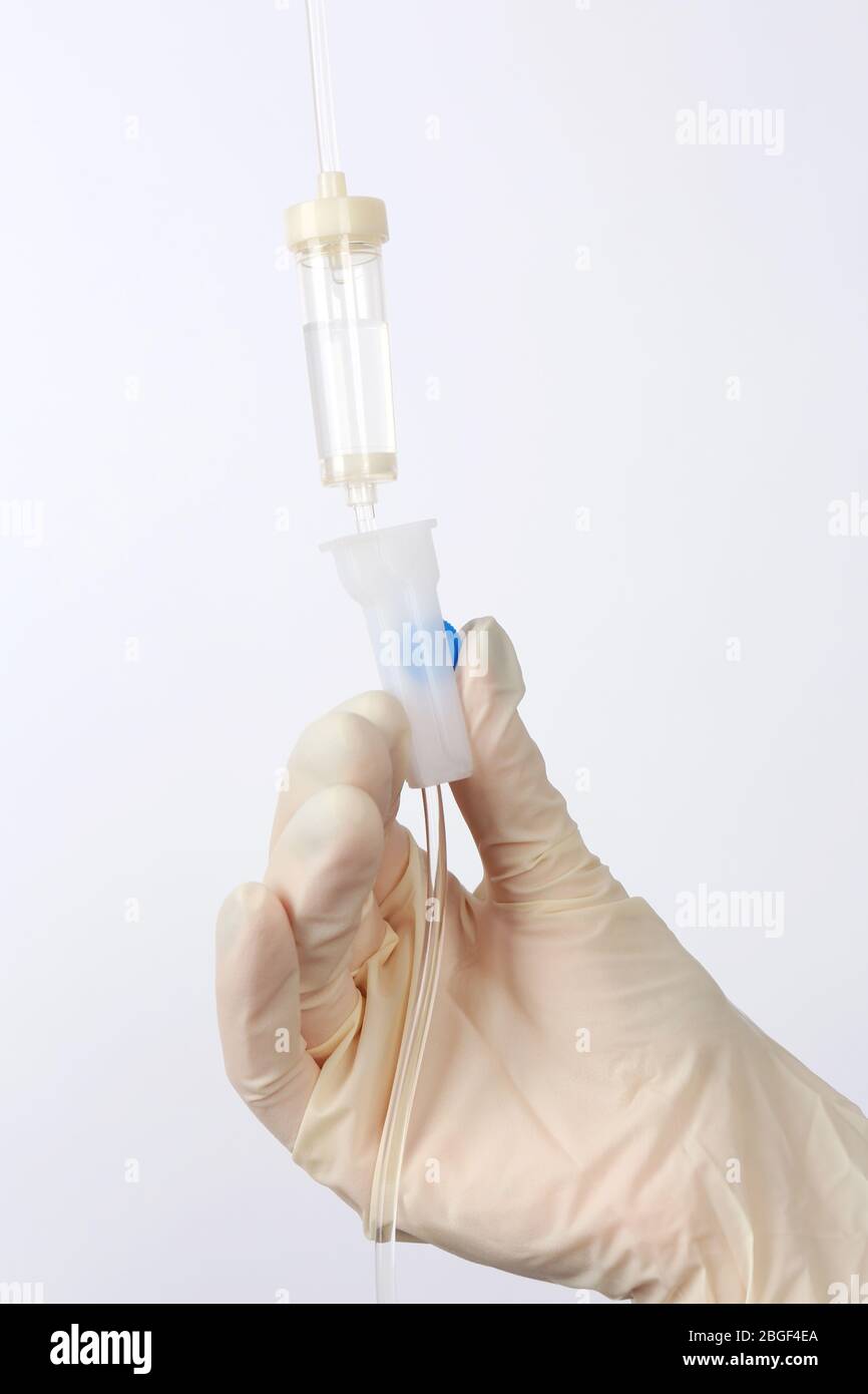 Disposable infusion set on grey background Stock Photo - Alamy