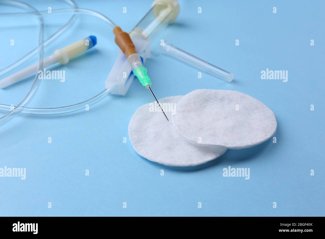 Disposable infusion set on blue background Stock Photo - Alamy
