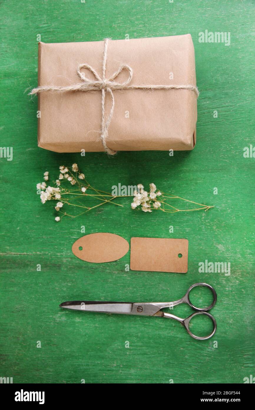 Natural style handcrafted gift box on color wooden background. Concept ...