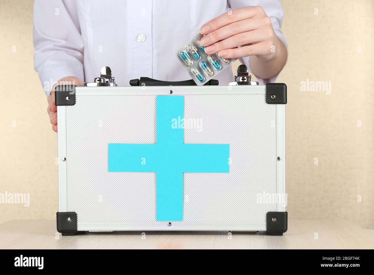 Nurse holding first aid kit, close up Stock Photo - Alamy
