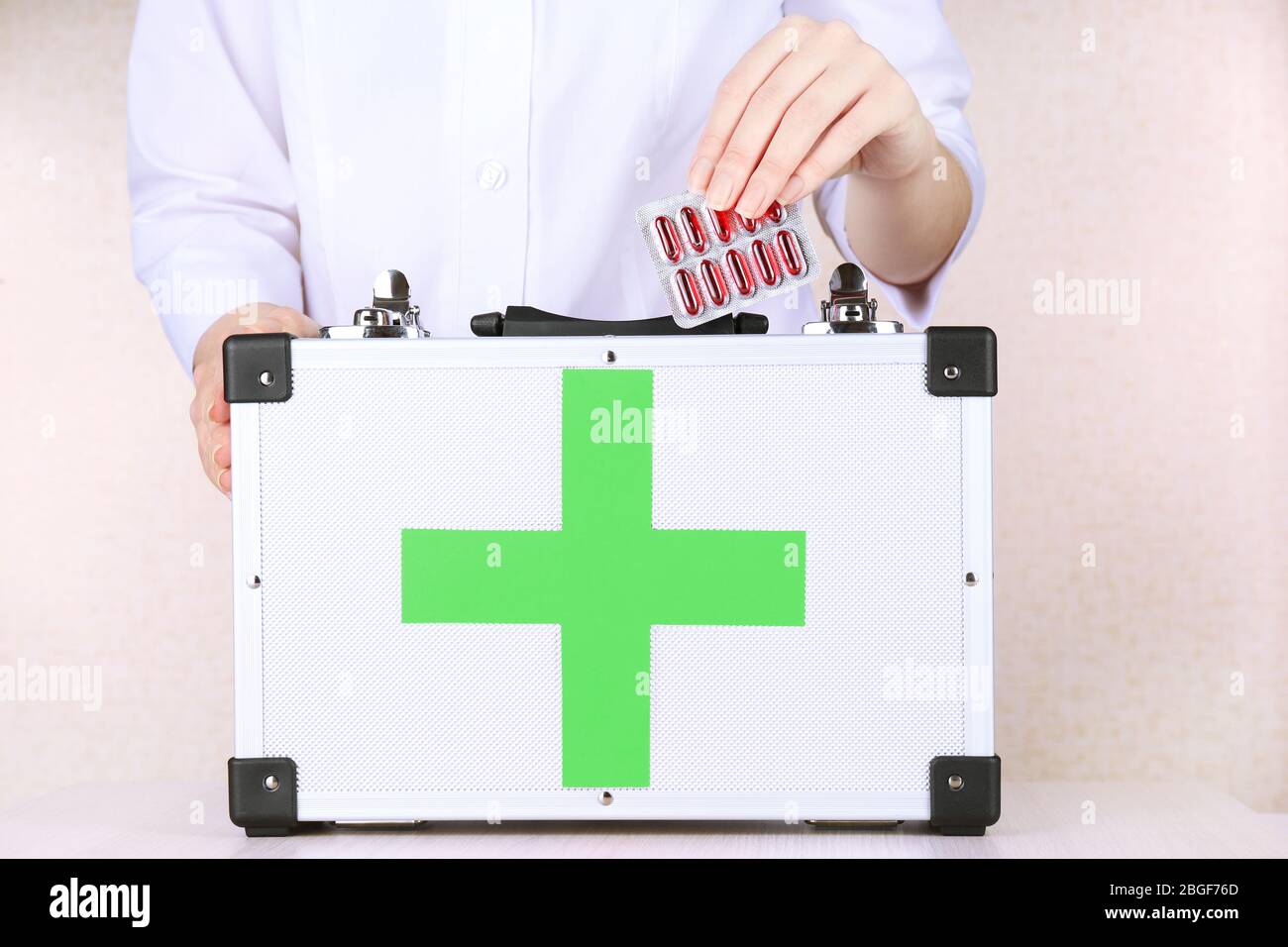 Nurse holding first aid kit, close up Stock Photo - Alamy