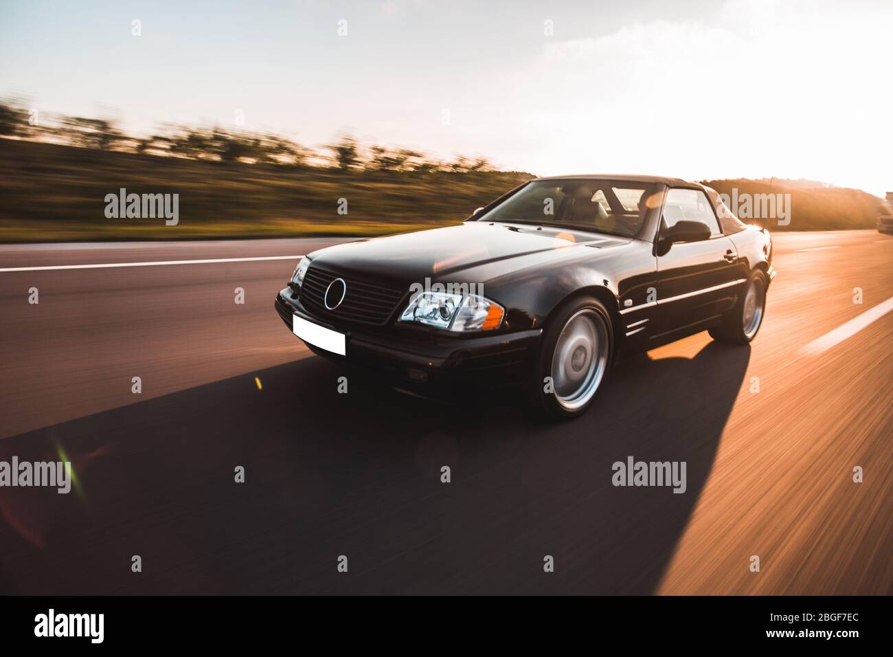 Old model sedan car in the downtown road in the sunset Stock Photo - Alamy