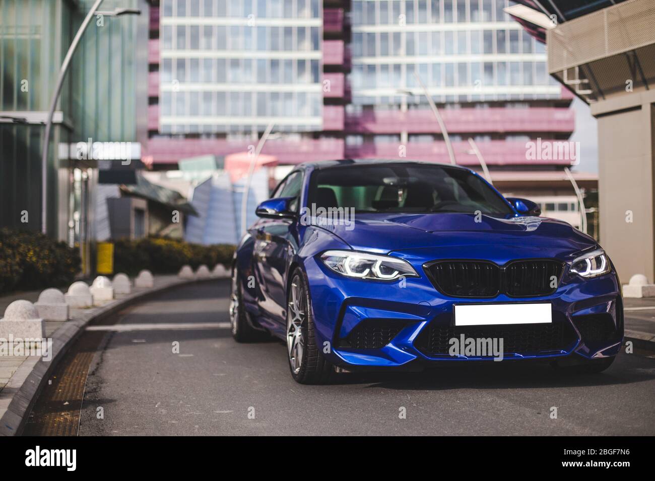 Blue design racing car in front of a showroom Stock Photo - Alamy
