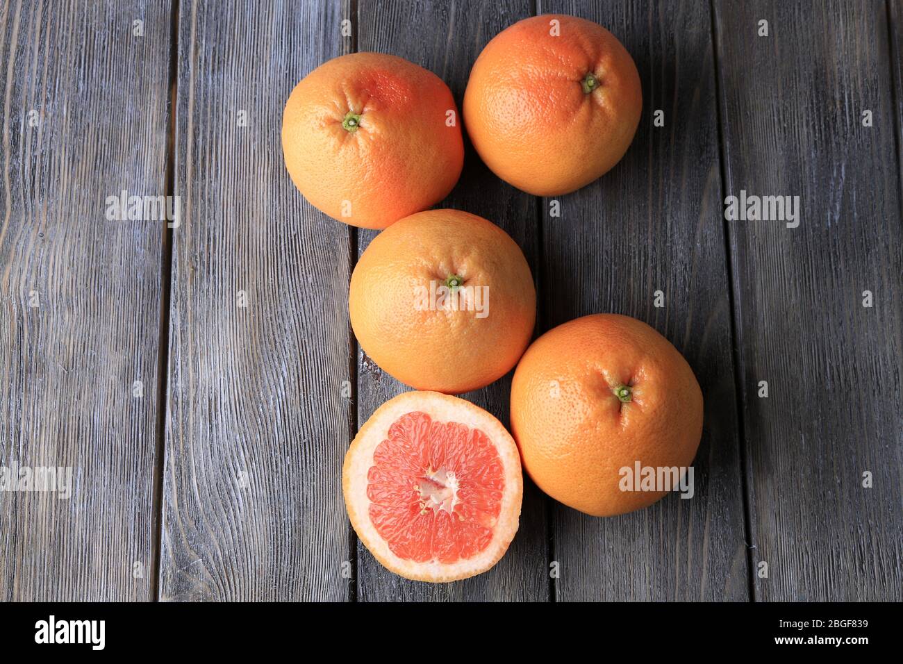 Ripe grapefruits on wooden background Stock Photo - Alamy