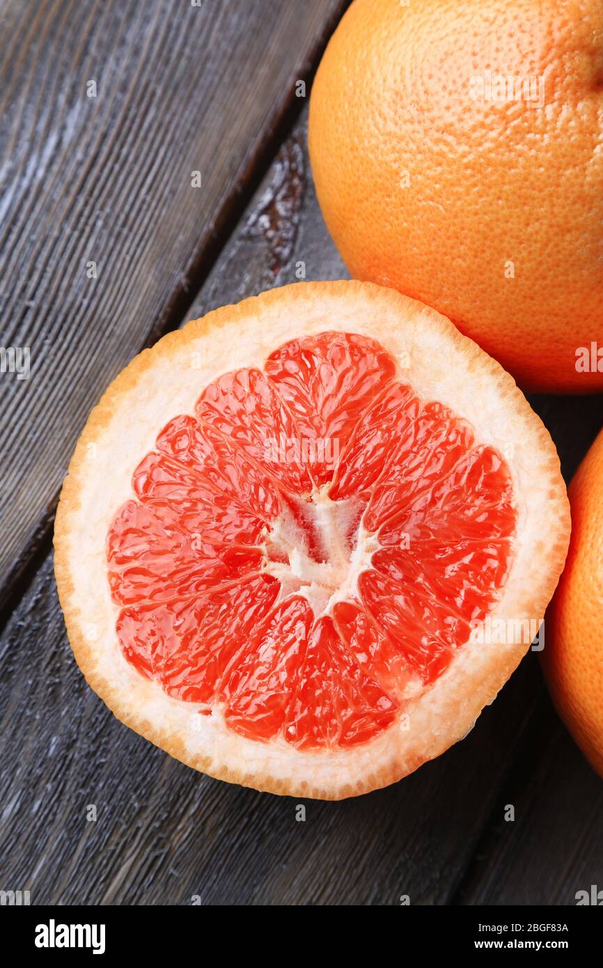 Ripe grapefruits on wooden background Stock Photo - Alamy