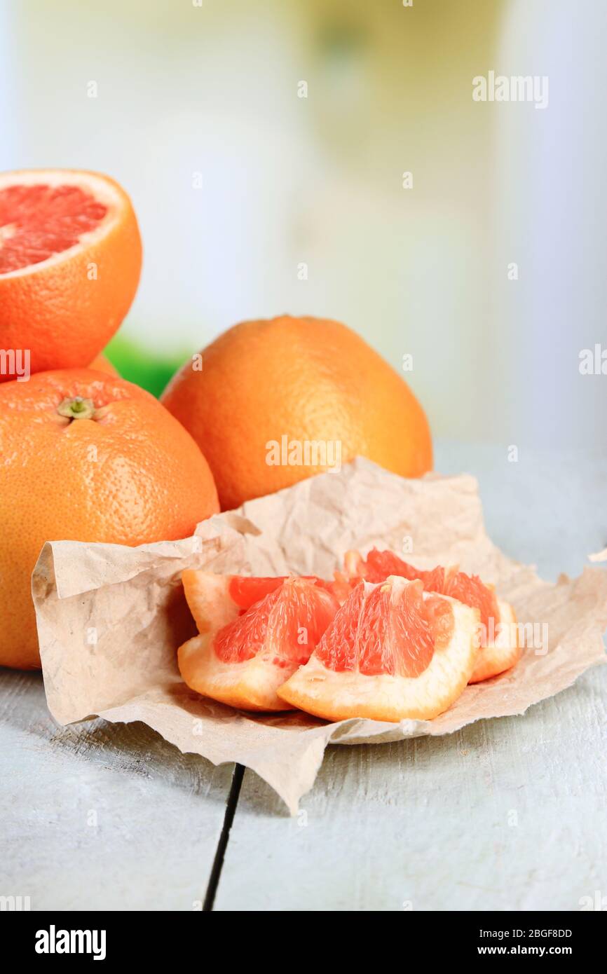 Ripe grapefruits on wooden board, on bright background Stock Photo - Alamy