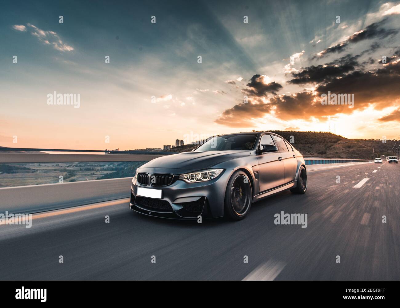 Speed drive in the downtown with a black sedan at the seaside Stock ...