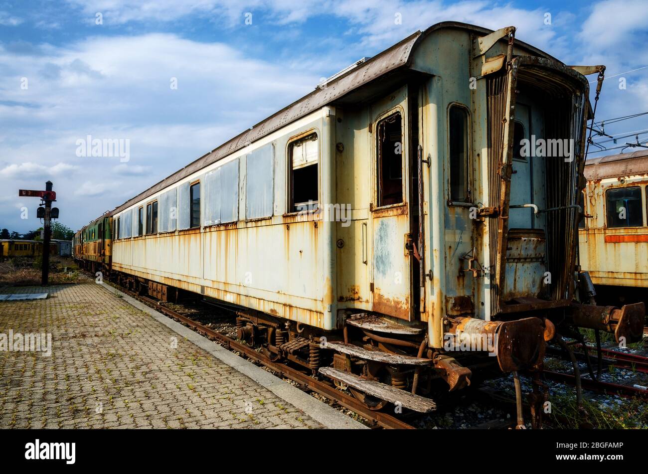 rusty old railcars and trains on an abandoned rail platform Stock Photo ...