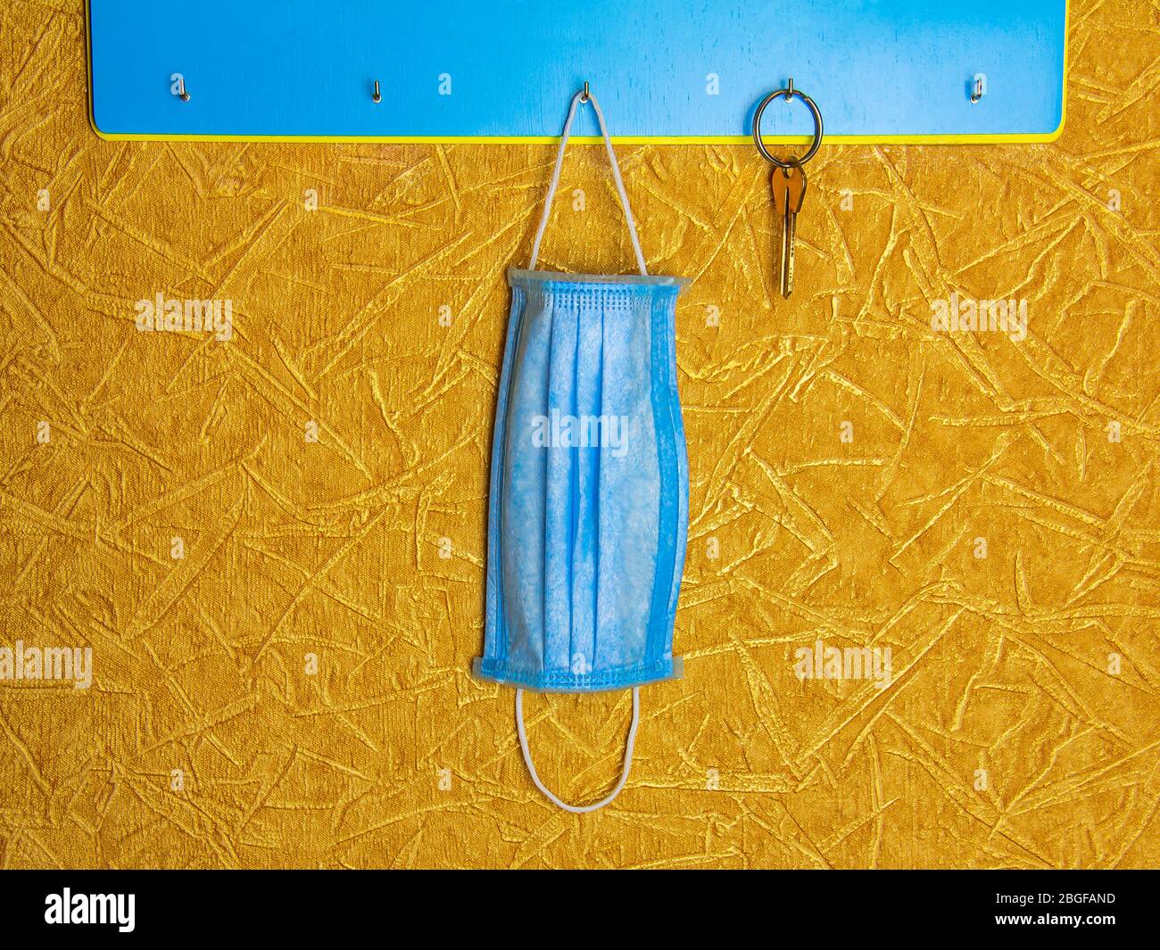 A medical mask on a hook, used to go out during a coronavirus pandemic ...