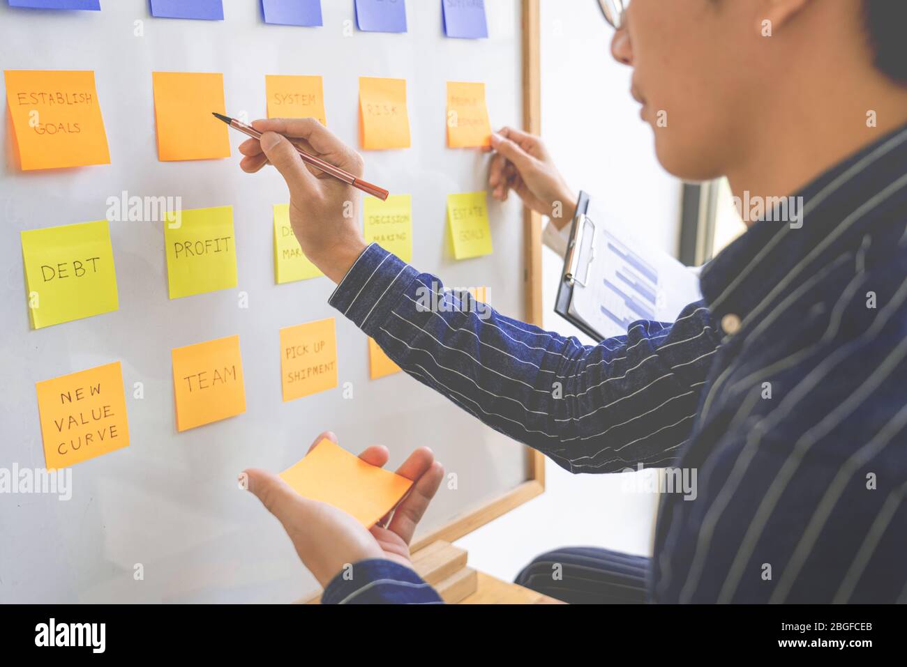 young business workers posting with sticky notes stickers reminders ...