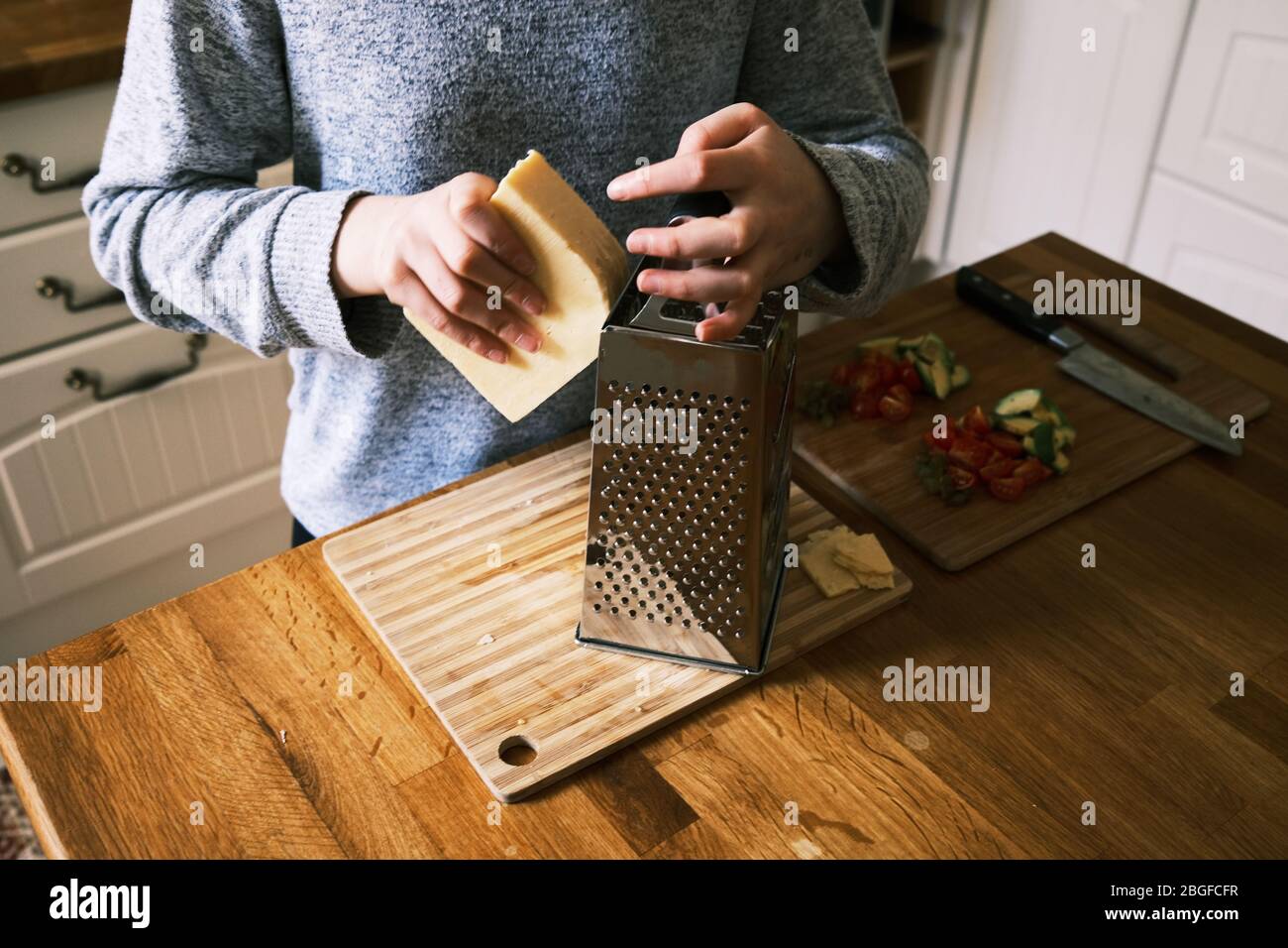 Child grate cheese hi-res stock photography and images - Alamy