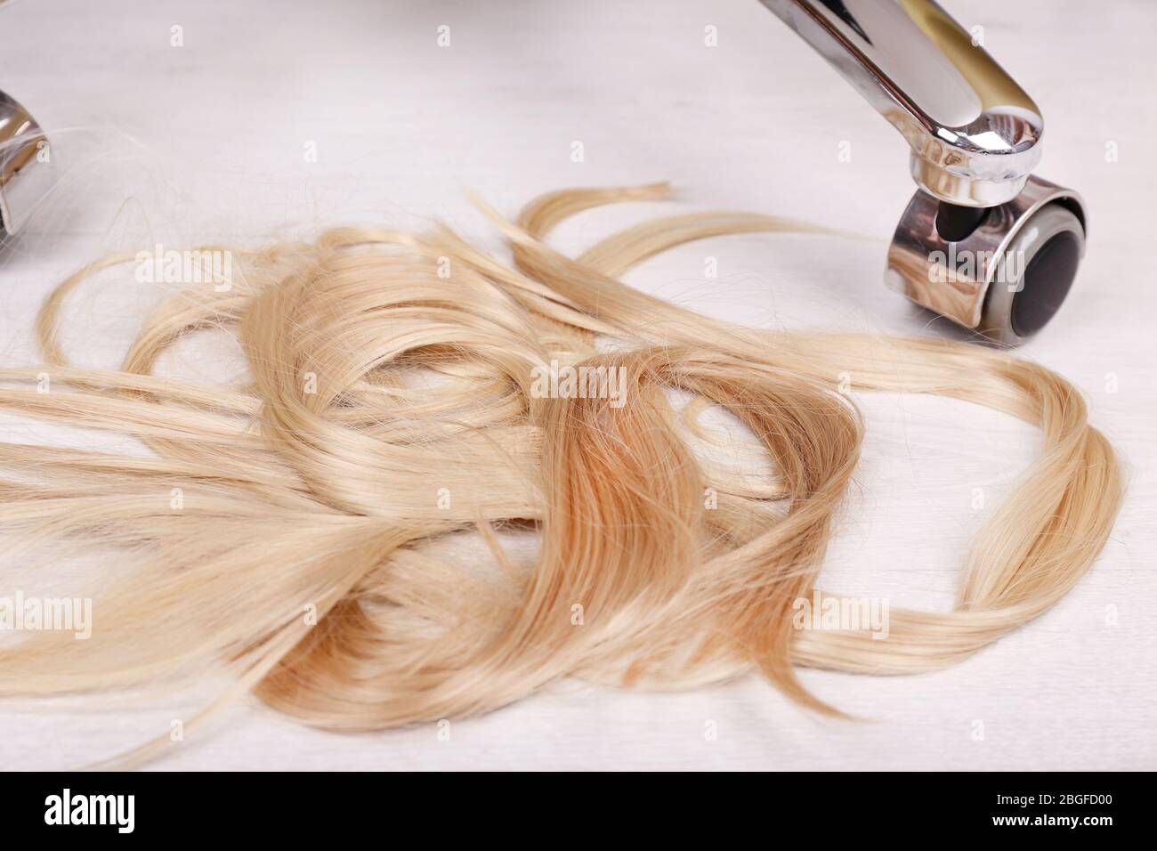 Cut hair on the floor in hairdressing salon, close up Stock Photo - Alamy
