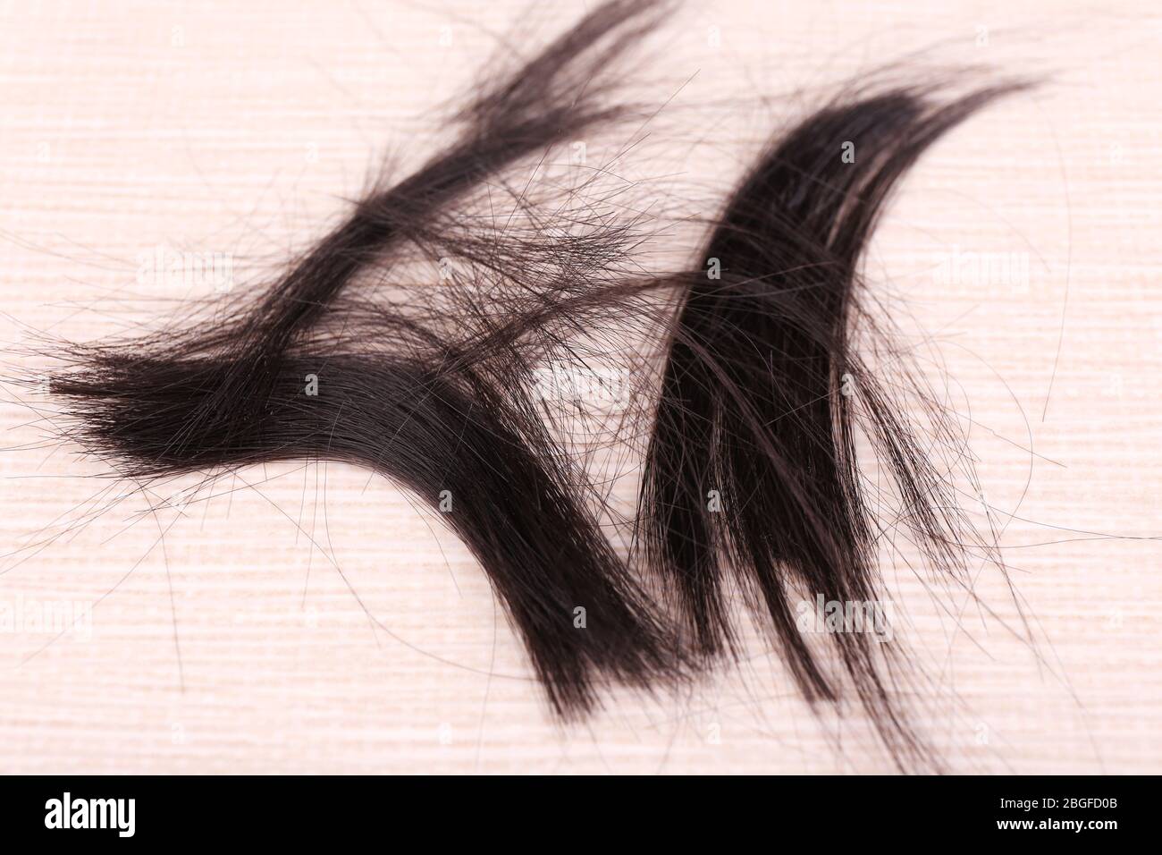 Cut hair on tile background Stock Photo - Alamy