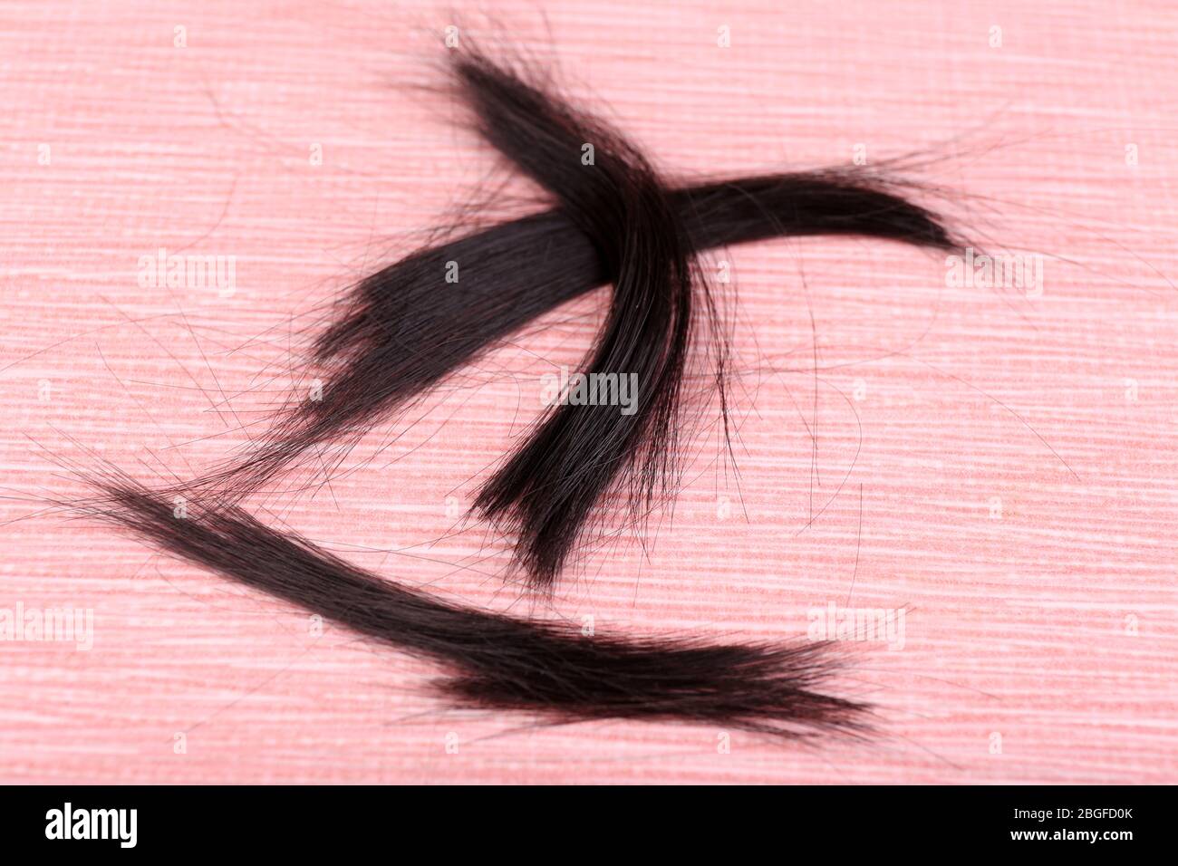 Cut hair on tile background Stock Photo - Alamy