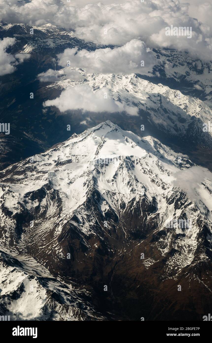 Austrian Alps mountains seen from an airplane window Stock Photo - Alamy
