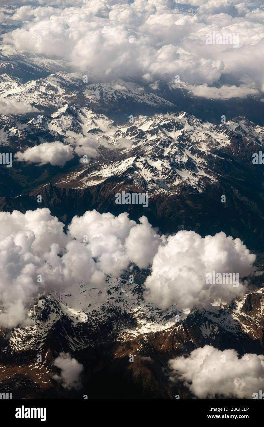 Austrian Alps mountains seen from an airplane window Stock Photo - Alamy