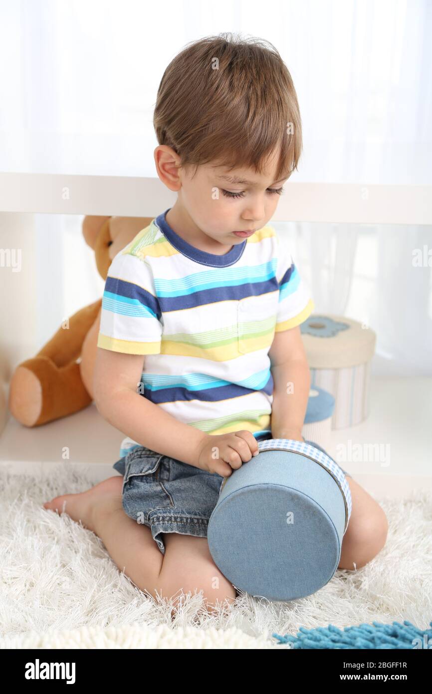Cute little boy playing in room Stock Photo - Alamy