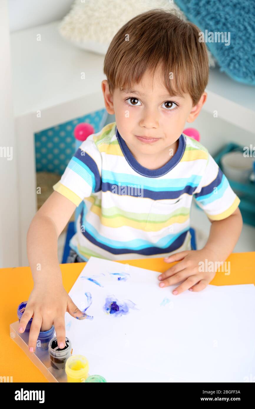 Cute little boy painting in room Stock Photo - Alamy