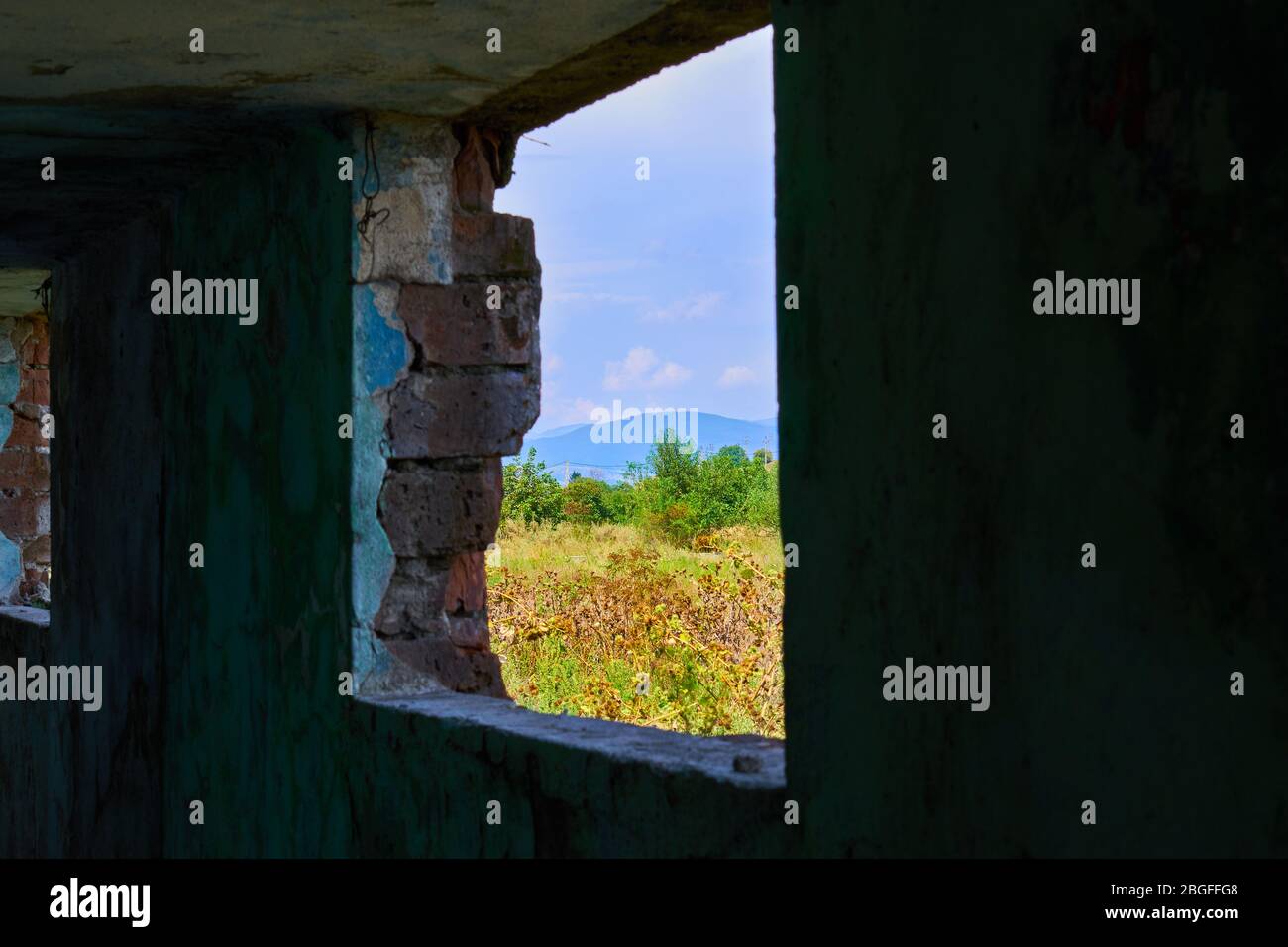 the view through a window from the Interior of an abandoned building in ...