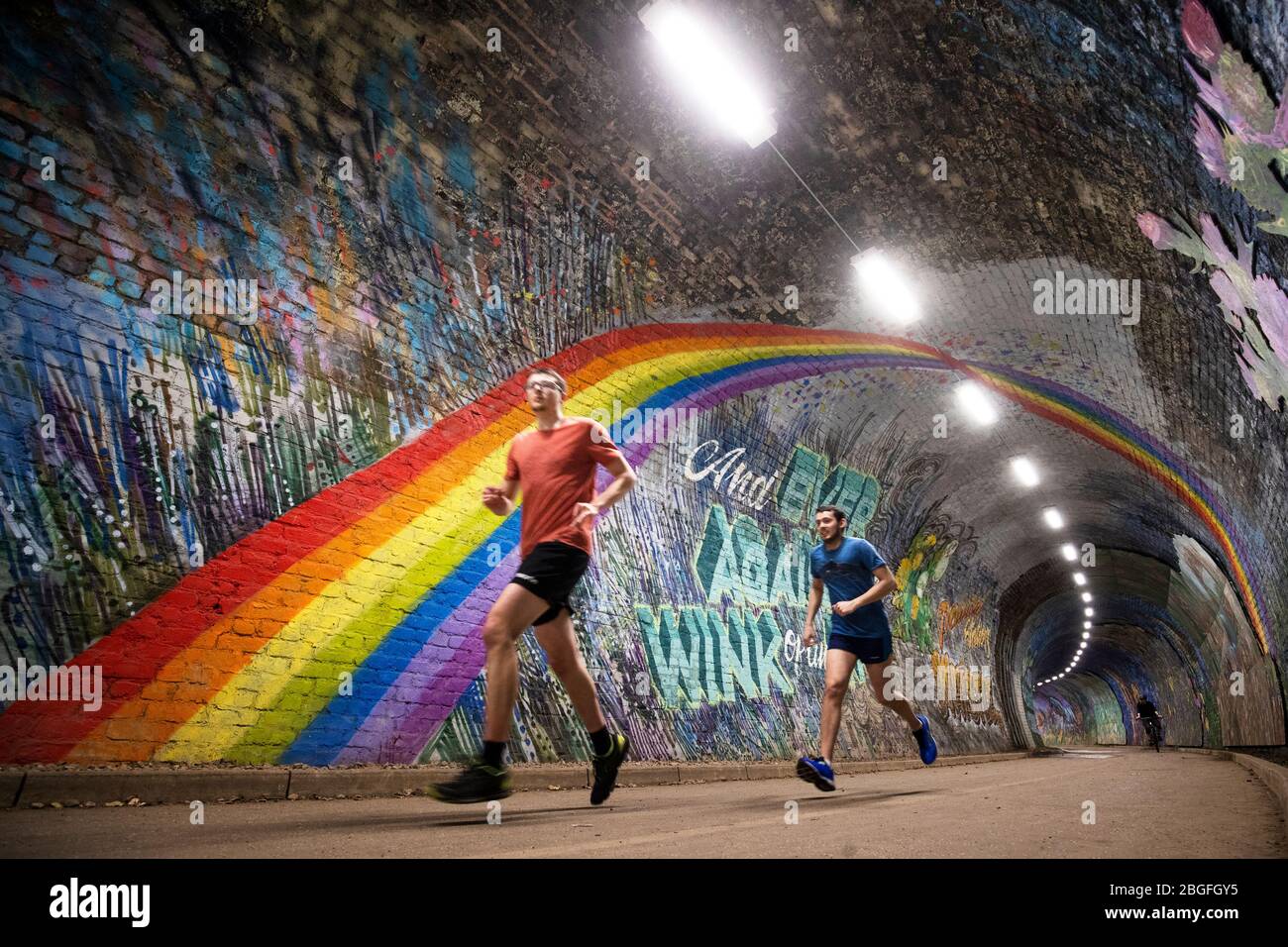 People taking their daily exercise pass underneath the rainbow mural in ...