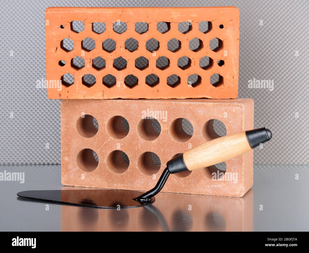Metal tool for building and bricks on bright background Stock Photo - Alamy