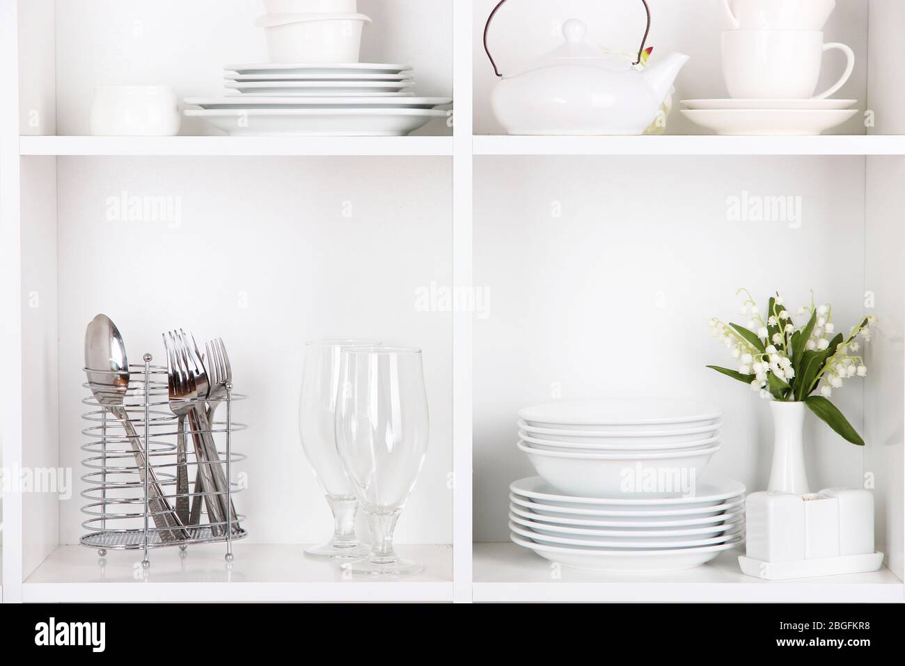 Different white clean dishes on wooden shelves Stock Photo - Alamy