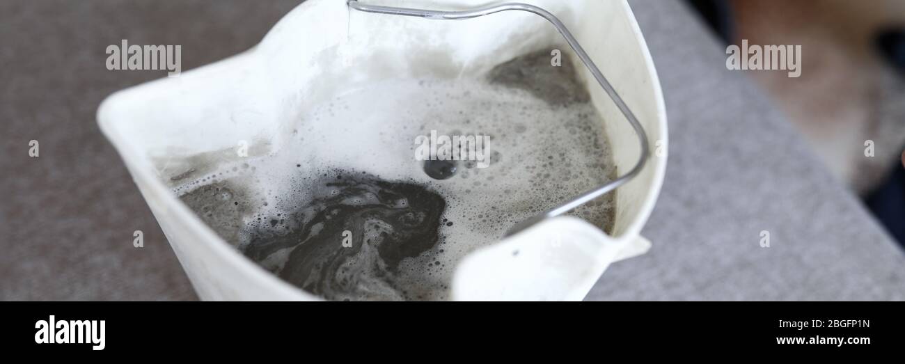 Plastic vacuum cleaner tank full of dirty water Stock Photo - Alamy