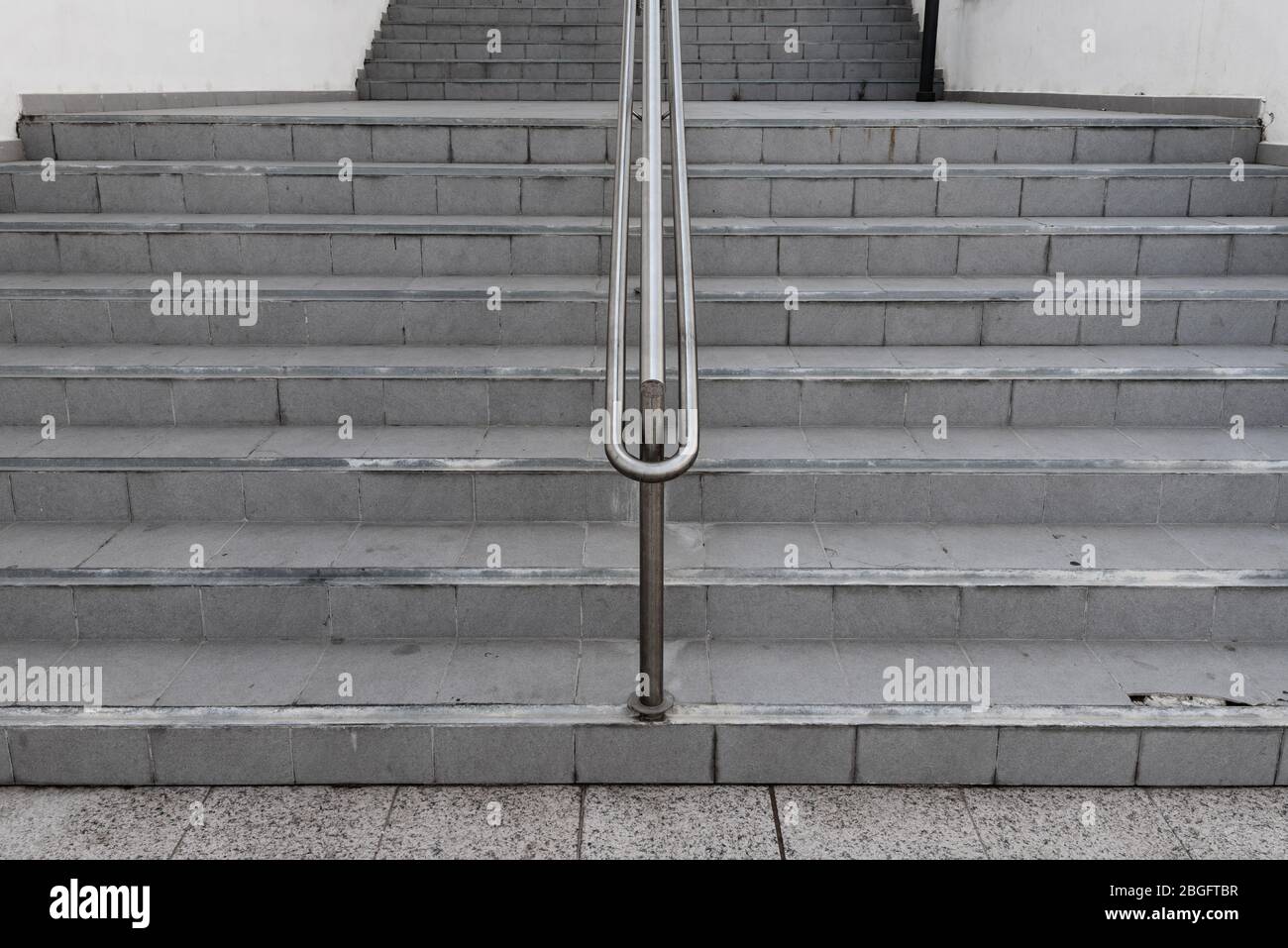 Symmetrical ladder stairway with hand railing on the middle Stock Photo ...