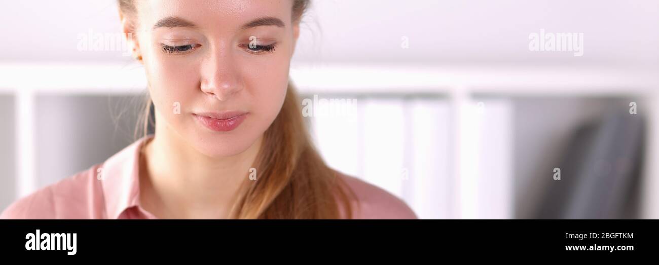 Girl works in office looking down concentrated Stock Photo - Alamy