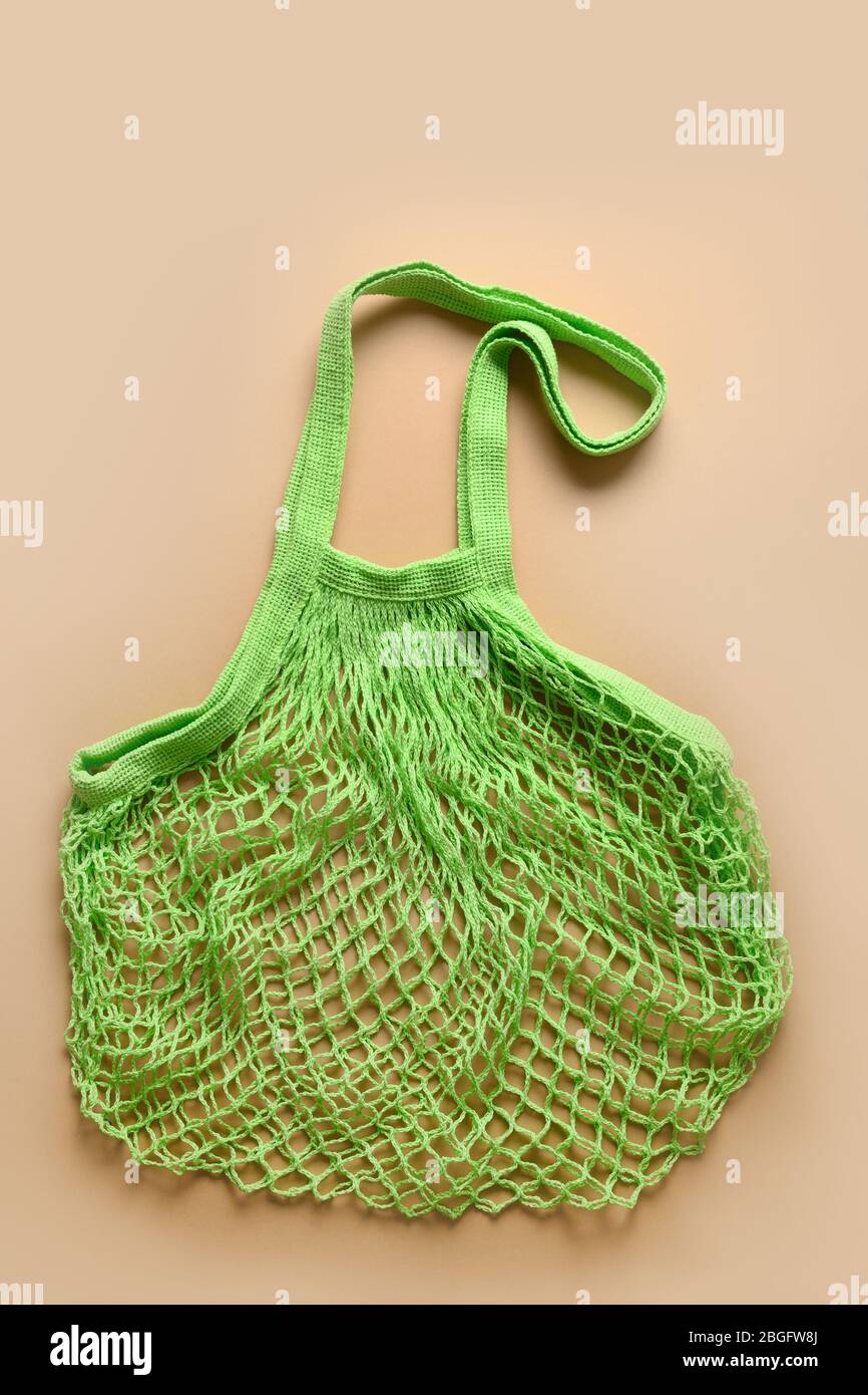 Empty eco shopping green mesh bag on beige. Zero waste concept. View ...