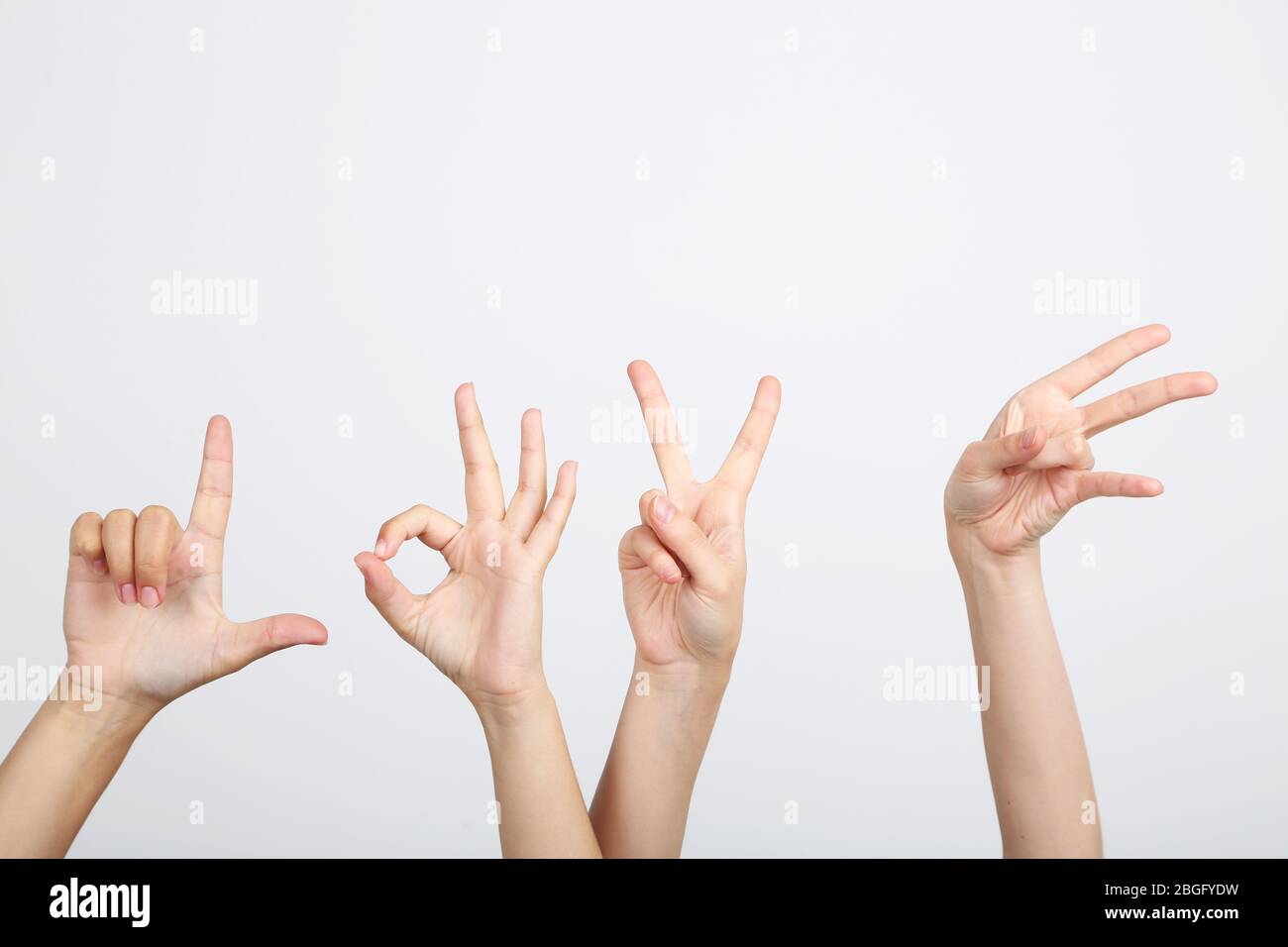 People show different signs of hands on grey background Stock Photo - Alamy