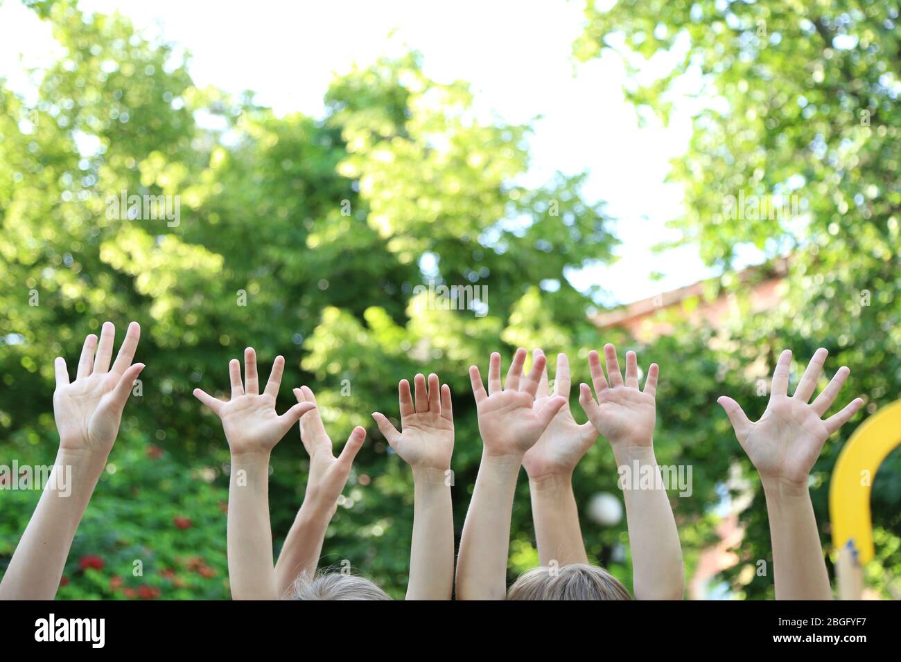 People hands up on natural background Stock Photo - Alamy