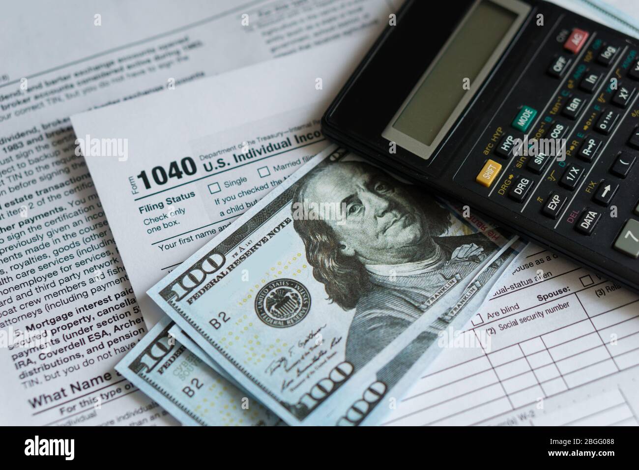 Business and tax concept. Tax form 1040, pen and calculator on the desk ...