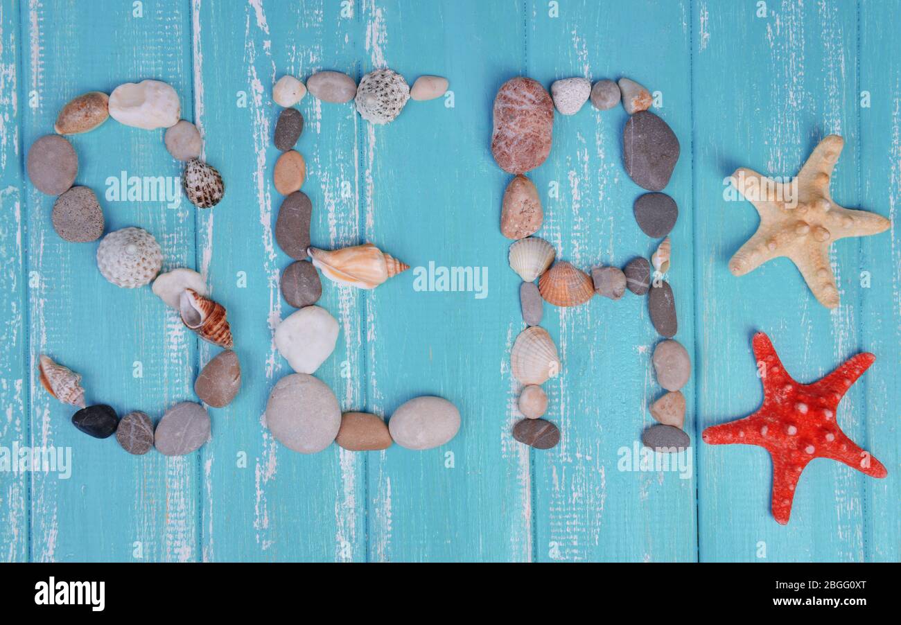 Word sea made from sea shells and stones on wooden background Stock ...