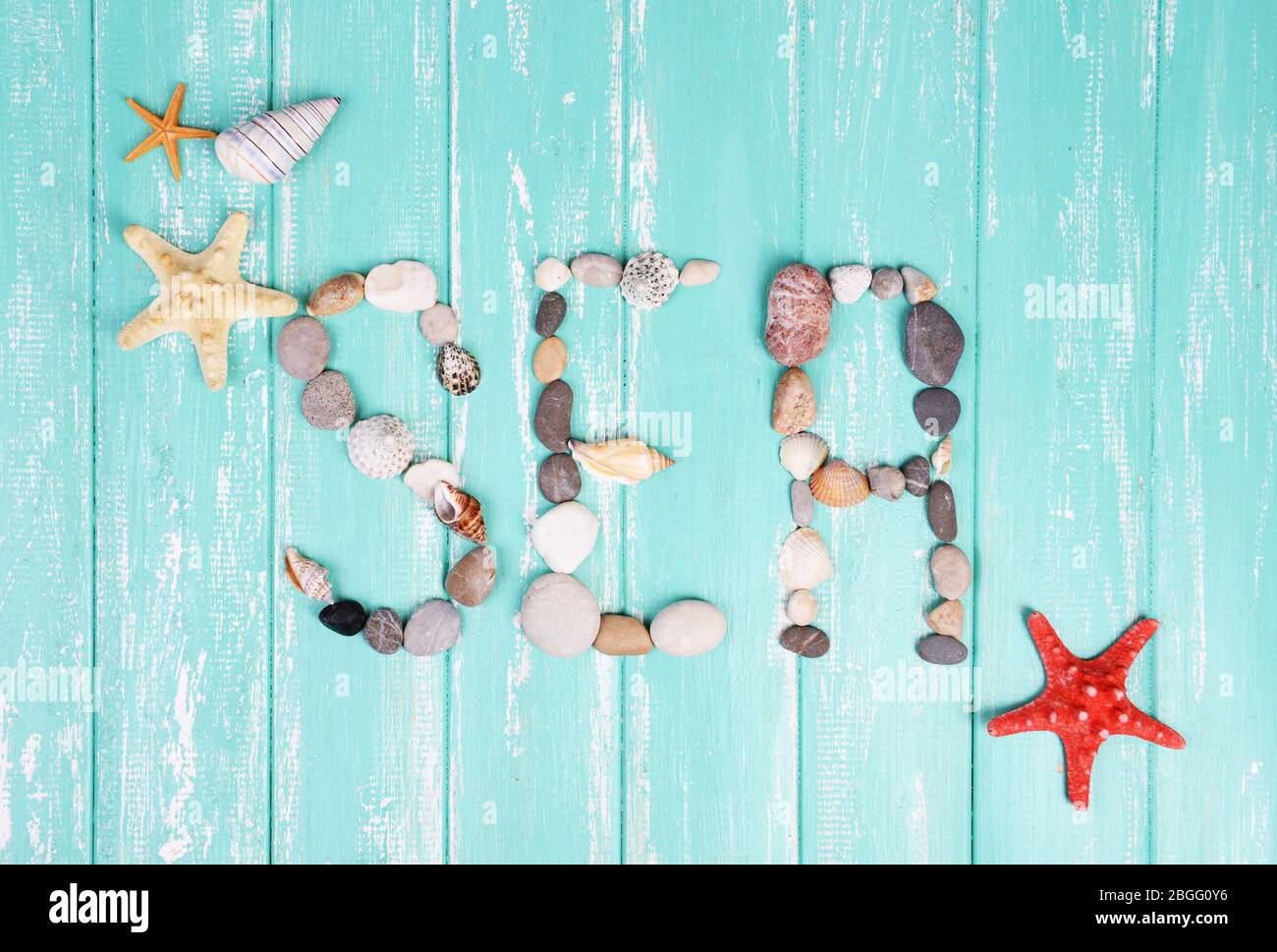 Word sea made from sea shells and stones on wooden background Stock ...
