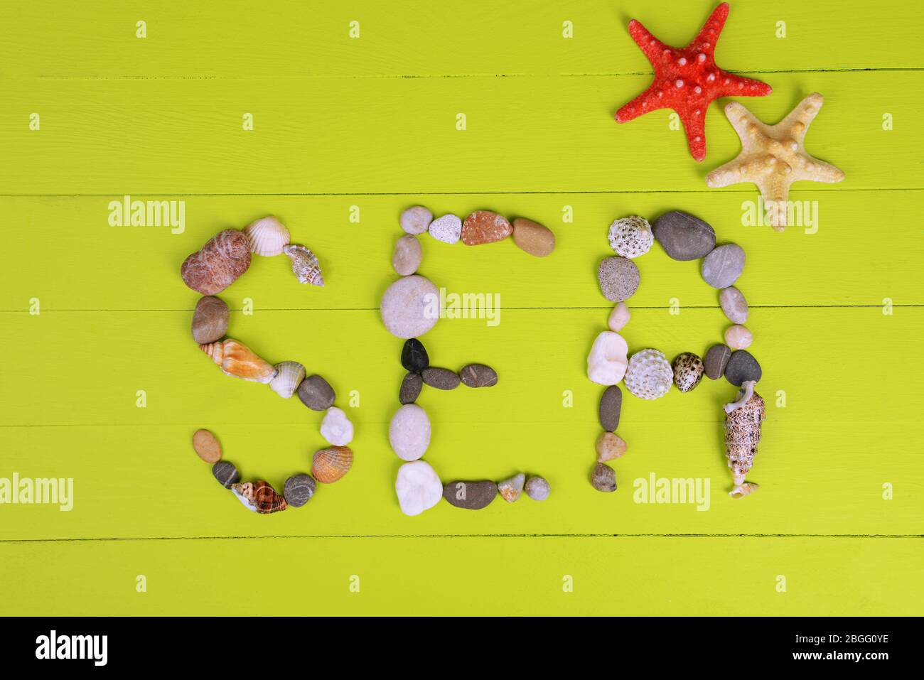 Word sea made from sea shells and stones on wooden background Stock ...