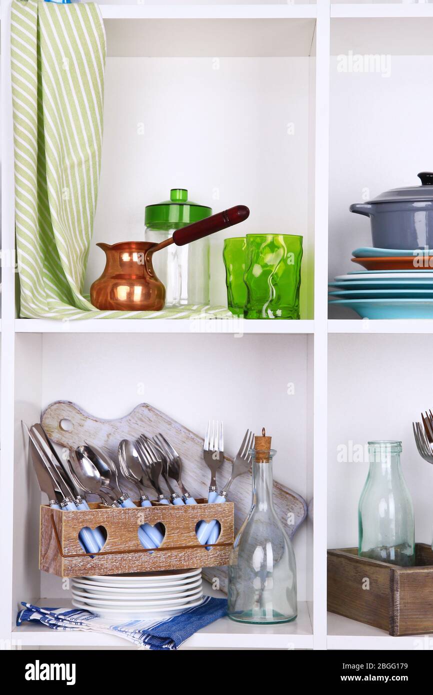 Kitchen utensils and tableware on beautiful white shelves Stock Photo ...